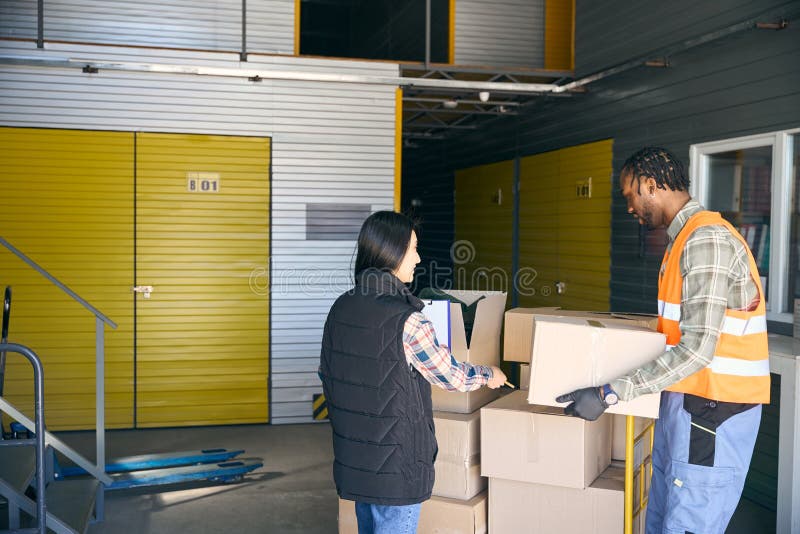 Freight Handler Transporting Goods on Wheeled Cart in Warehouse Stock ...