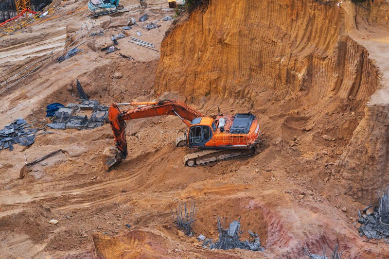 Modern Excavator Digs the Ground Under Foundation Pit at a Construction ...