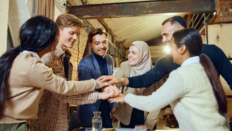 Multicultural Team in Open, Relaxed Office Setting Celebrates Unity by ...