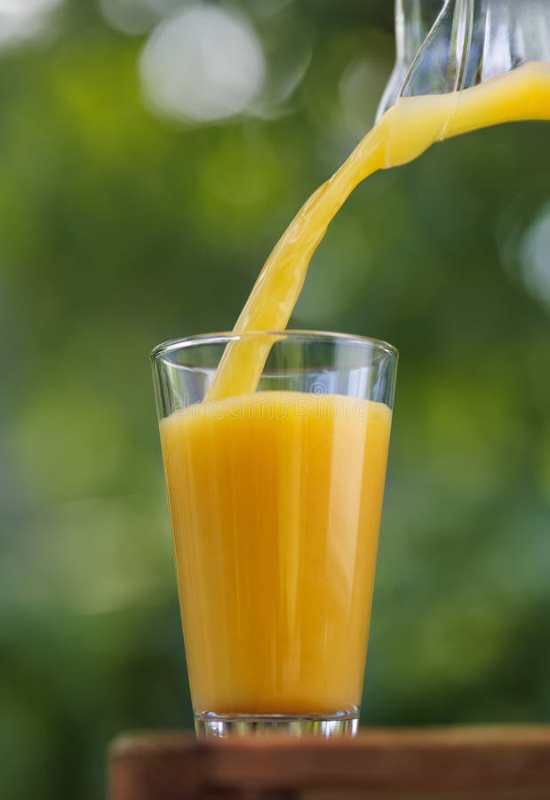 Orange Juice Pouring in Glass from Jug Stock Image - Image of full ...