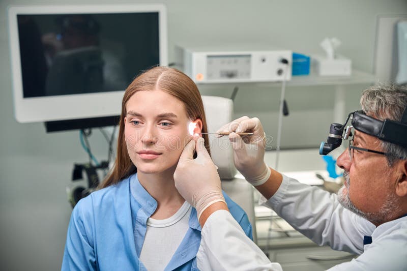 Female Patient Undergoing Ear Examination by Doctor Stock Photo - Image ...