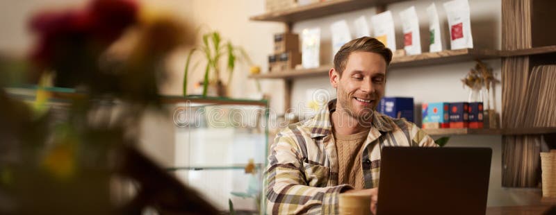 Portrait of Cafe Owner, Young Man Sitting in Coffee Shop with Laptop ...