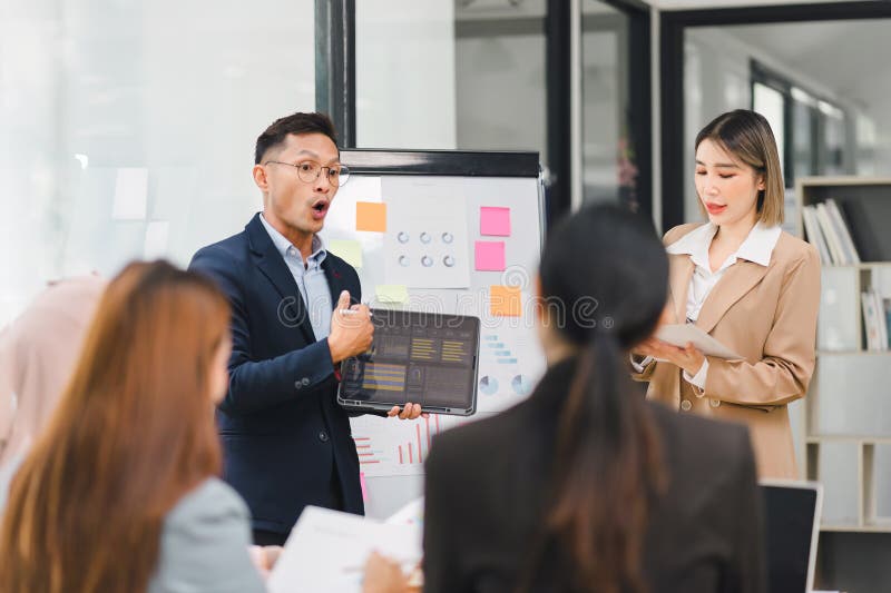 Professional Diverse Business Team Presenting and Discussing Data Charts and Graphs during ...