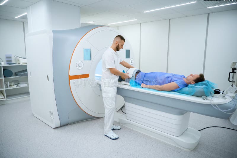 Medical Professional Preparing Man for MRI of Lower Limb Joint Stock ...