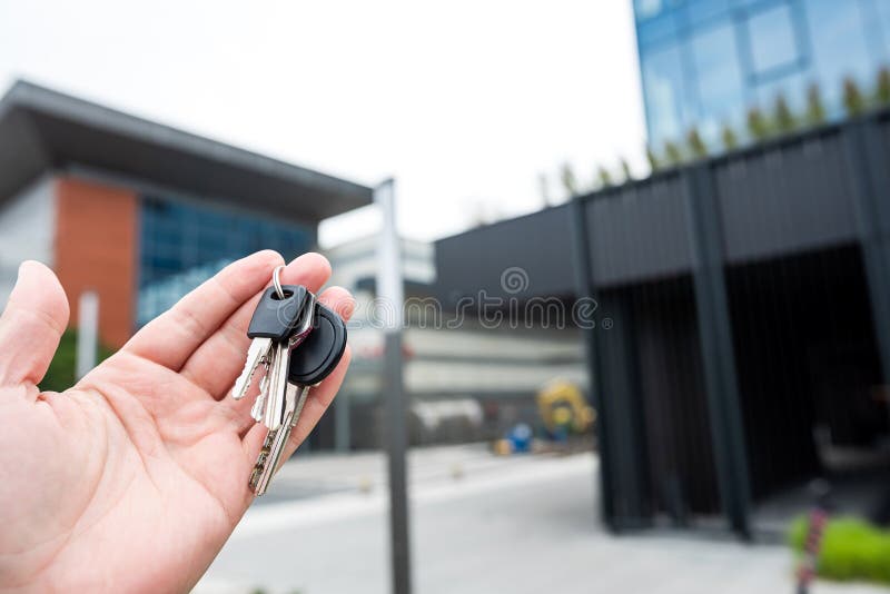 Real State Agent Show House Key Standing Outside at Office Center ...