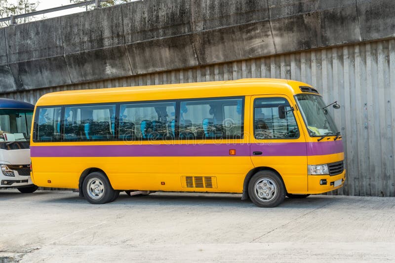 Small School Bus Parked in a Parking Lot. Stock Image - Image of ...