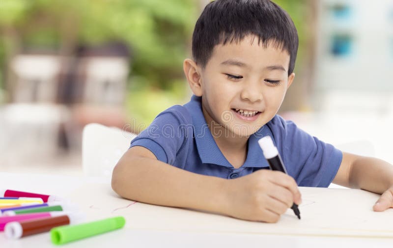 Smiling Asian Child Schoolboy Studying and Writing at Home Stock Photo ...