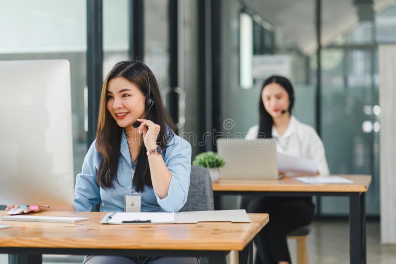 Smiling Call Center Agents Wearing Headsets, Working at Desks with ...