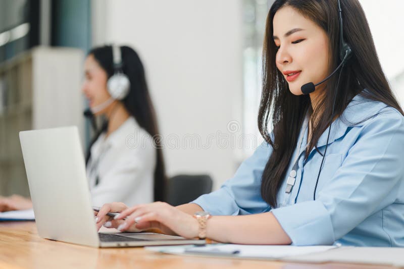Smiling Call Center Agents Wearing Headsets, Working at Desks with ...