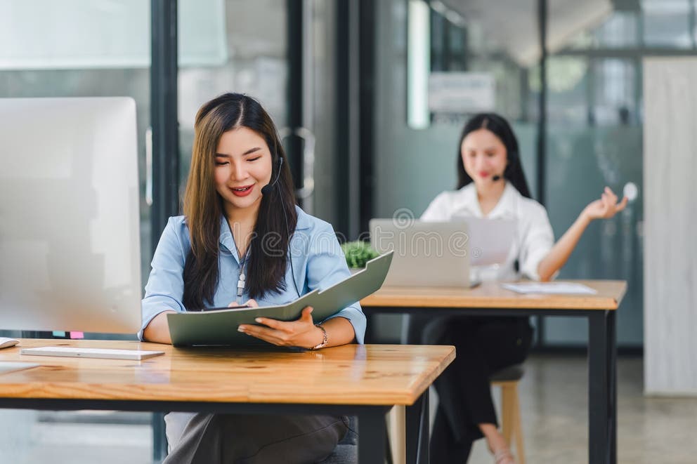 Smiling Call Center Agents Wearing Headsets, Working at Desks with ...