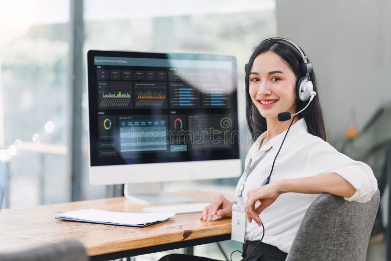 Smiling Operator Wearing Headset, Using Performance Dashboard on ...