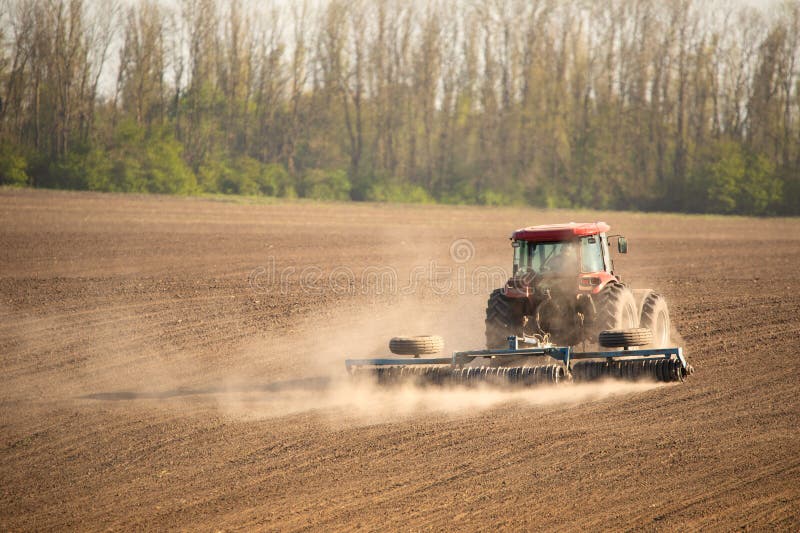 Harvesting Hope: Tractor Preparing the Ground Stock Photo - Image of ...