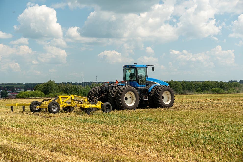 Tractor Working in a Field on a Bright Sunny Day. the Concept of Work ...