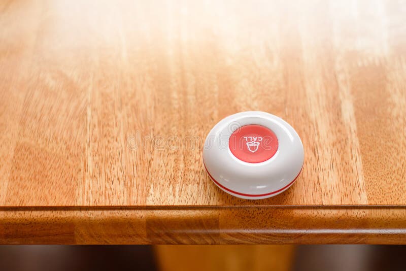 A White Call Button with a Red Center and the Word "CALL" Printed on it ...