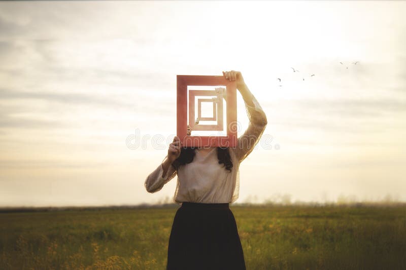 Woman Holding a Loop of Empty Frames that Makes Her Face Disappear ...