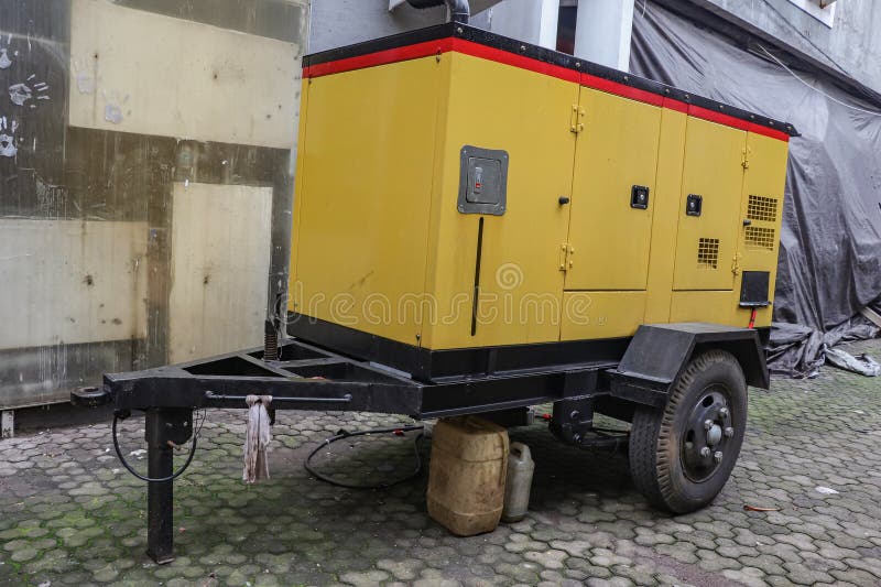 Yellow Portable Electric Generator in the Yard of the Building Complex ...