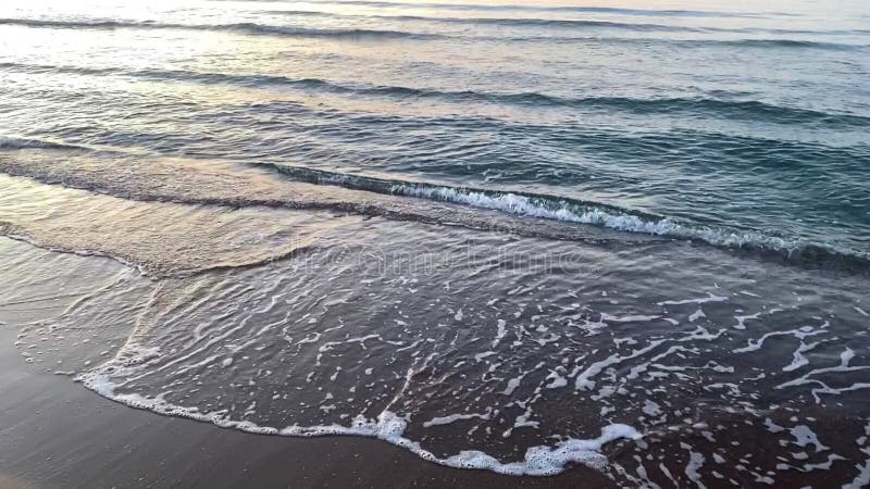 Gentle Ocean Waves Roll in Slow Motion Under a Glowing Sunset Sky Stock ...