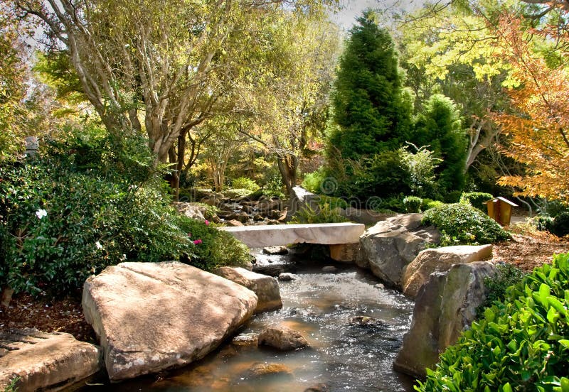 Gentle Stream with Stone Bridge Stock Image - Image of stone, flowers ...