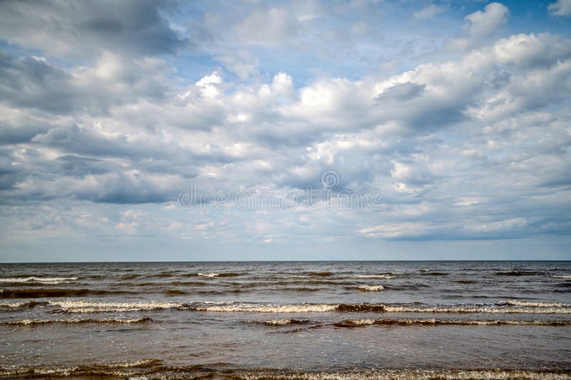 Gentle Waves Move Towards the Beach while Clouds Fill the Evening Sky ...