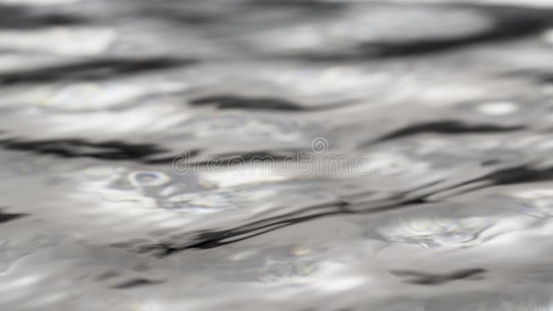 Gentle Waves Ripple Across a Deep Blue Water Surface, Creates a ...