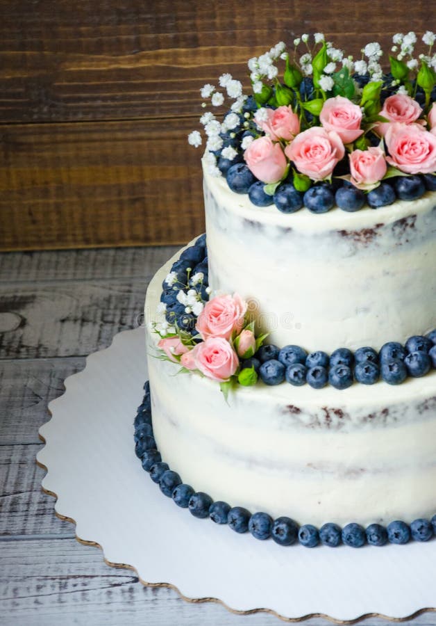 Gentle Wedding Cake with Blueberry and Roses Stock Photo - Image of ...