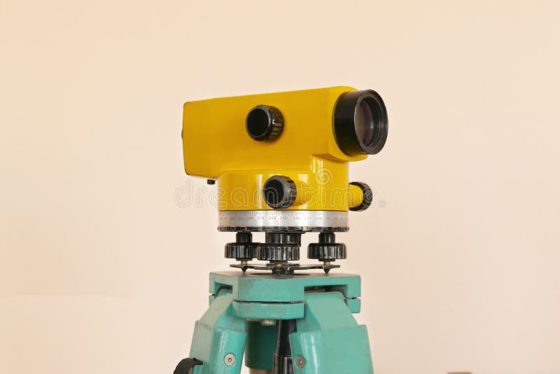 Geodesy Level Device on a Tripod with Ruler on the Background a ...