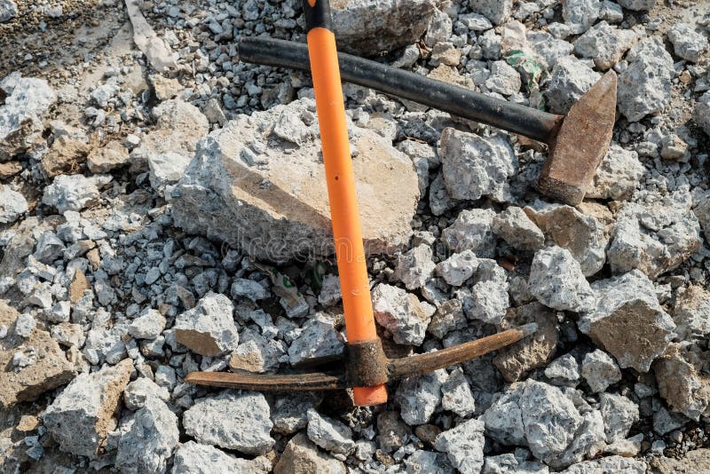 Geological Pick with Orange Handle on the Stones Next To Old Hammer ...