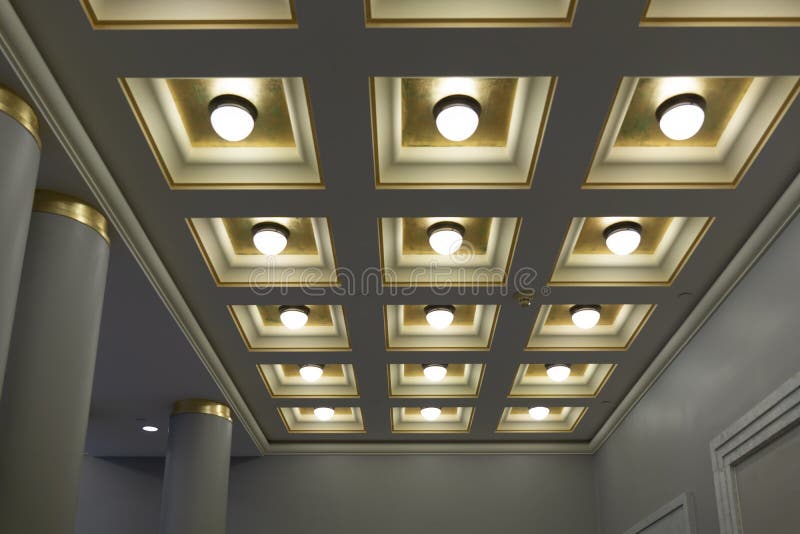 Geometric Ceiling with Square Boxes and Round Lamps in a Row Stock ...