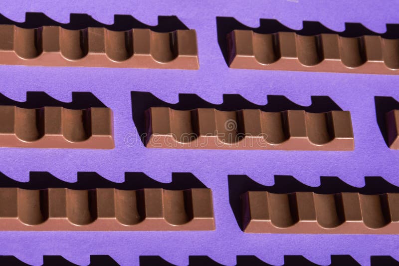 Geometric Chocolate Bars on Purple Background Stock Photo - Image of ...