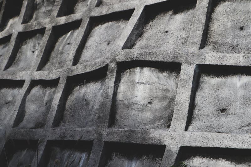 Geometric Concrete Wall with Grid-Like Patterns and Textured Surface ...