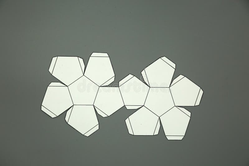 Geometric Shape Cut Out of Paper and Photographed on Grey Background ...