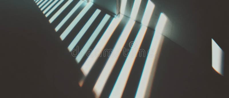 Shadows of Window Frames Create Geometric Patterns on a Dark Background ...