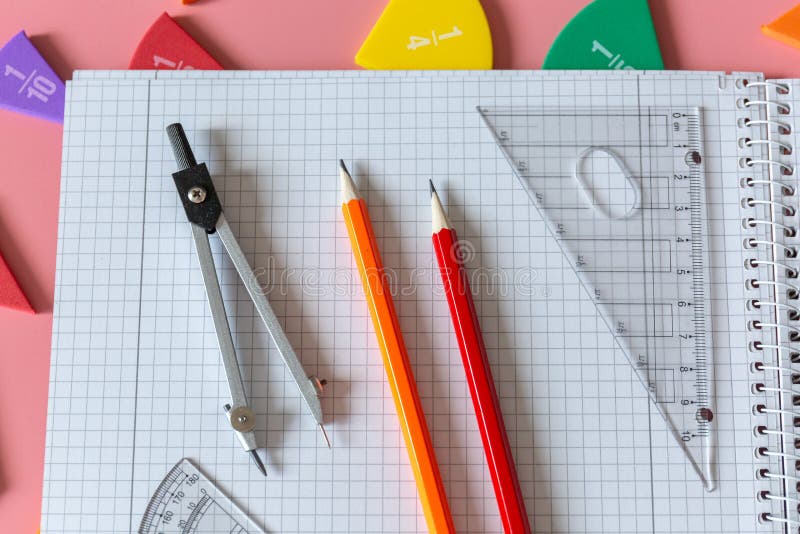 Geometry Set on Open Notebook. Compass Drawing Tool, Ruler, Pencils ...