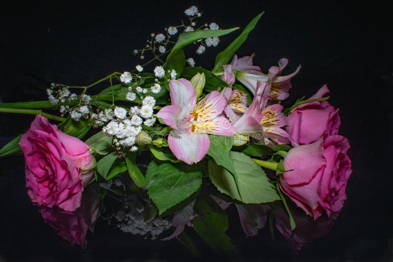 A Georgeous Reflection Flower Arrangement on a Black Surface Stock ...