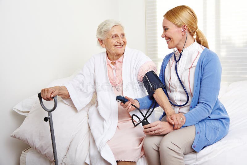 Geriatric Nurse Washing Bedridden Stock Image - Image of hands ...