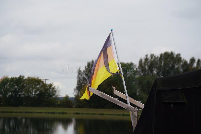 German Flag Hanging by the Tent on the Lake Forest Stock Image - Image ...