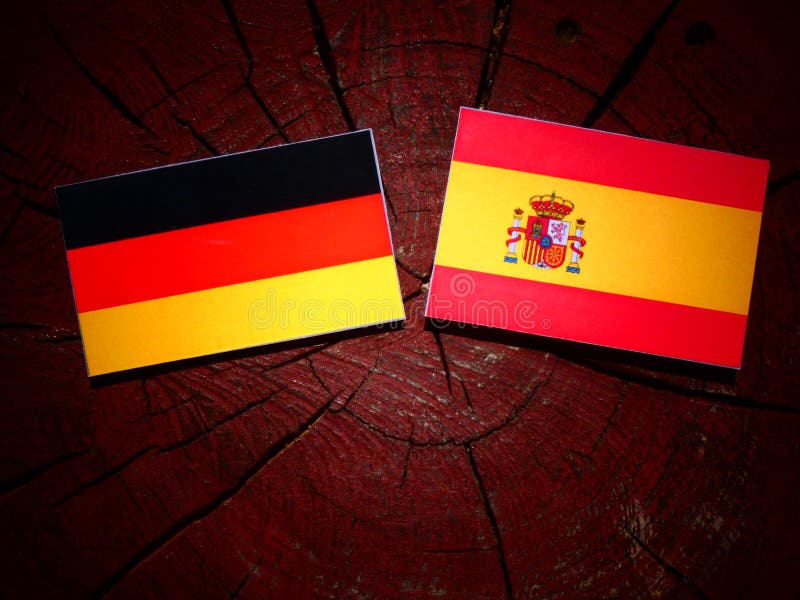 German Flag with Spanish Flag on a Tree Stump Stock Photo - Image of ...