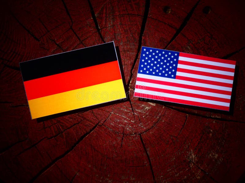 German Flag with USA Flag on a Tree Stump Stock Photo - Image of crisis ...