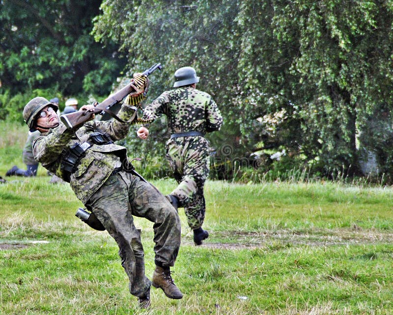 German Soldiers-reenactors Leave the Battle Field Holding Guns ...