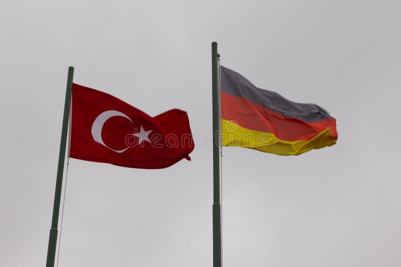 German and Turkish Flags on the Flagpole with Overcast Sky on the ...