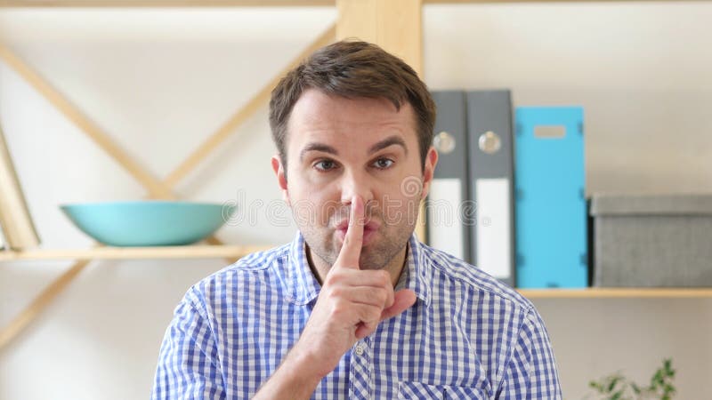 Gesturing of Silence by Man Sitting in Office Stock Photo - Image of ...