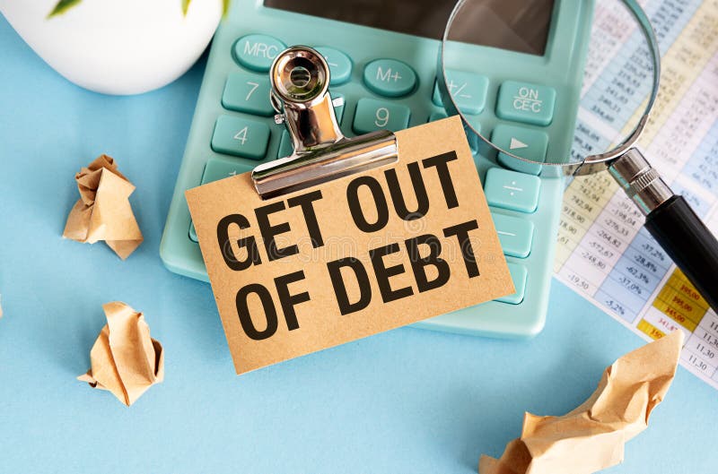 GET OUT of DEBT Text on Paper with Calculator, Notepad, Pen with Money ...