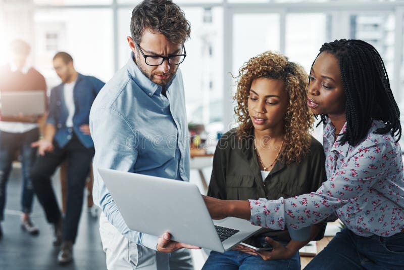 Get the Team on it and Get it Done. a Group of Colleagues Using a ...