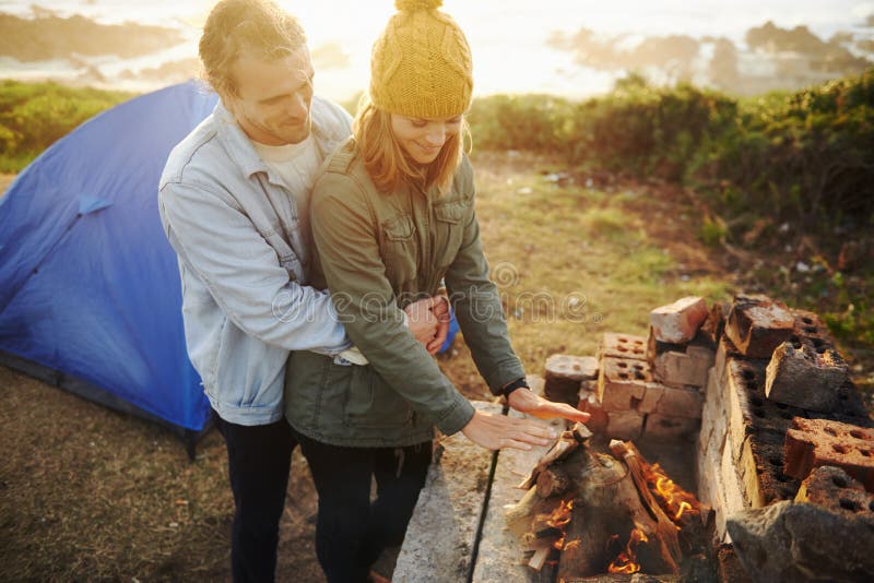 Getting the Campfire Started. an Affectionate Young Couple Getting Warm ...