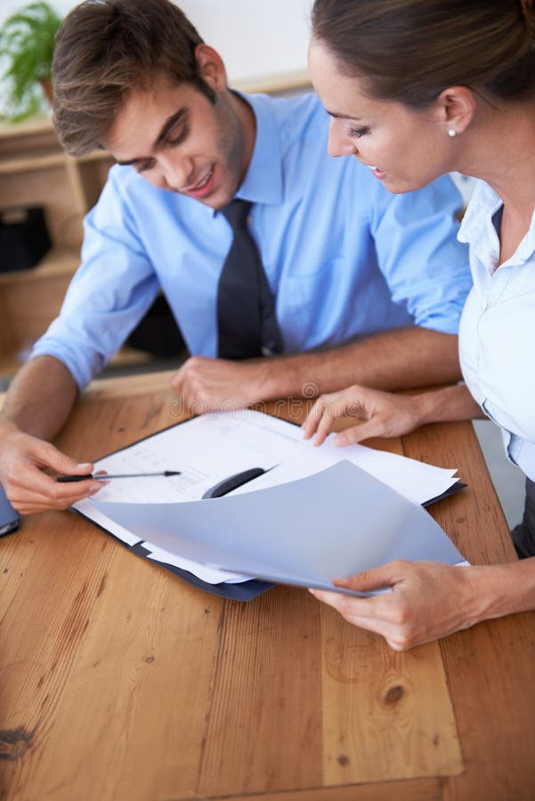 Getting into the Contract Nitty-gritty. Two Young Businesspeople ...