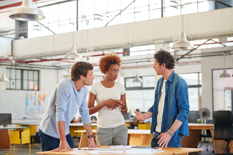 Getting into the Details. a Group of Colleagues Collaborating with Each ...