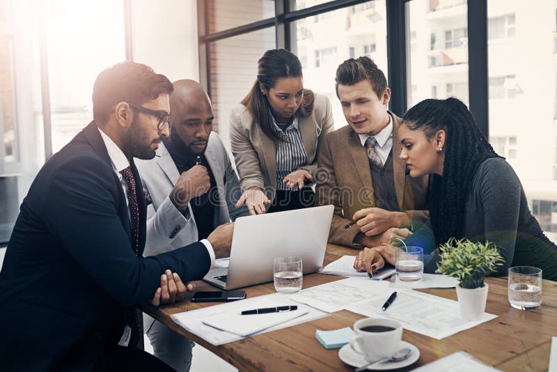 Getting it Done Quicker with Technology and Teamwork. a Group of Young ...