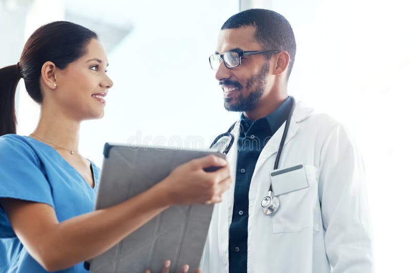 Getting Down To Diagnosing. Two Young Doctors Using a Digital Tablet in ...