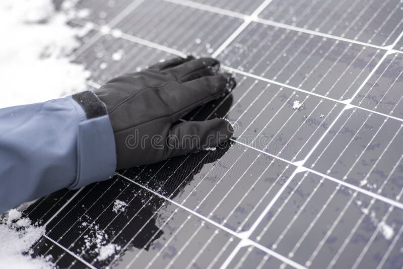 Getting Electricity with Solar Panels in Winter.Hands Clear Snow from ...