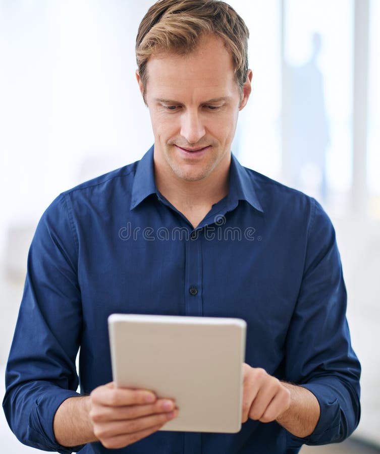 Getting those Emails Out of the Way. a Handsome Man Using His Tablet at ...